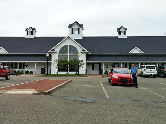 The white farmhouse exterior of Berlin Farmstead stands like a culinary lighthouse in Amish Country, beckoning hungry travelers with promises of comfort food paradise.