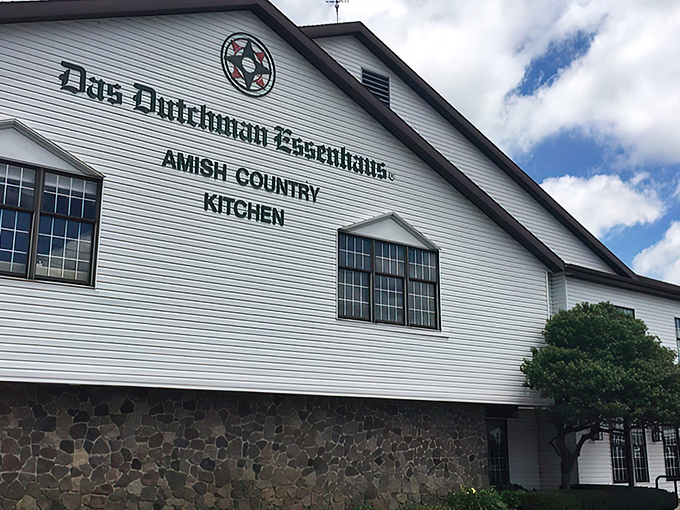 The white clapboard exterior of Das Dutchman Essenhaus stands like a time portal to simpler days, promising comfort food that'll hug your soul.