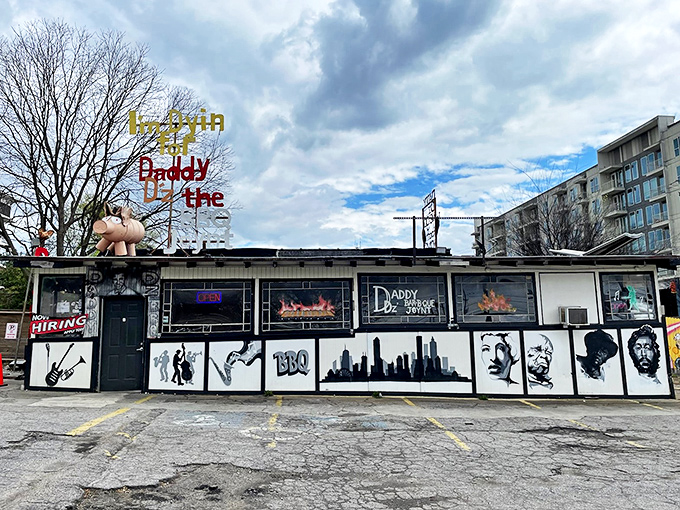 The unassuming exterior of Daddy D'z, complete with iconic flying pig sign, proves the golden rule of BBQ: the more weathered the building, the better the food.