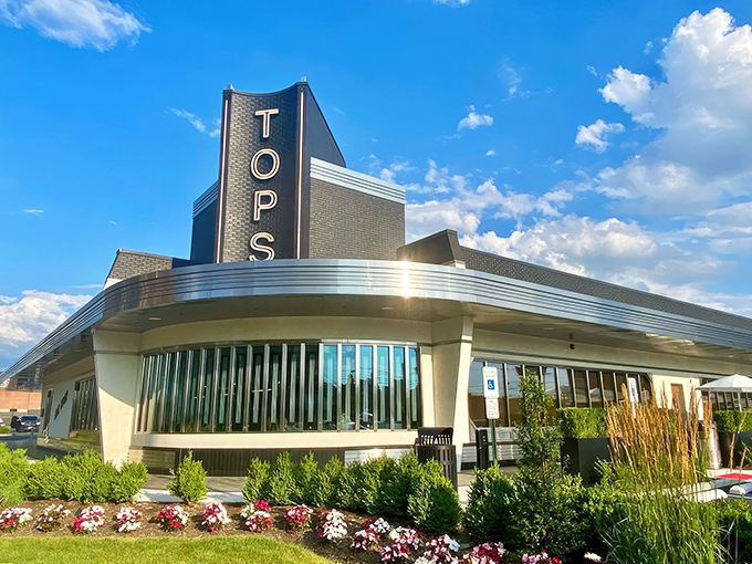 The sleek, modern exterior of Tops Diner stands like a culinary lighthouse, beckoning hungry travelers with its iconic signage and Art Deco-inspired design.