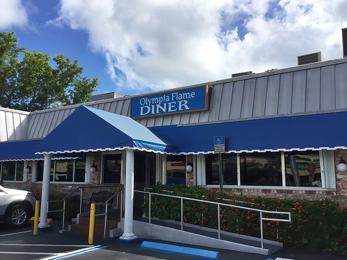 The iconic blue awning of Olympia Flame Diner stands as a beacon of comfort food in Deerfield Beach, promising Greek-inspired delights inside.