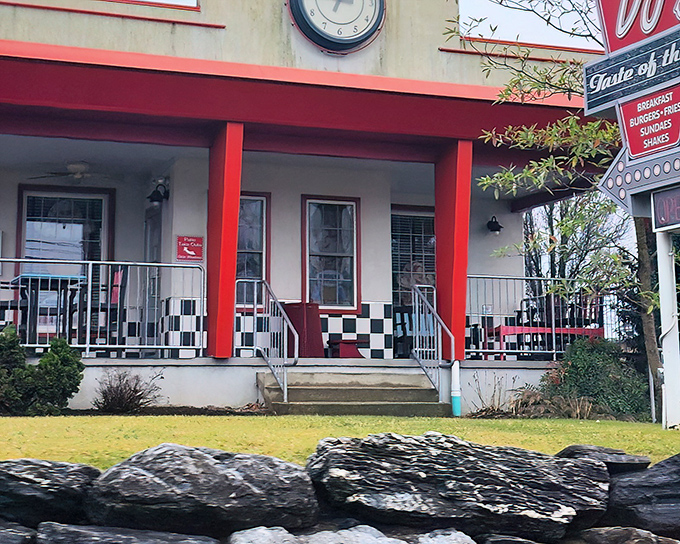The classic red-trimmed exterior with checkerboard porch isn't just nostalgic design&mdash;it's a time portal disguised as a diner entrance.