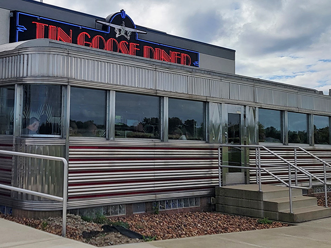 The gleaming stainless steel exterior of Tin Goose Diner shines like a beacon of nostalgia against the Ohio sky, promising comfort food with a side of aviation history.