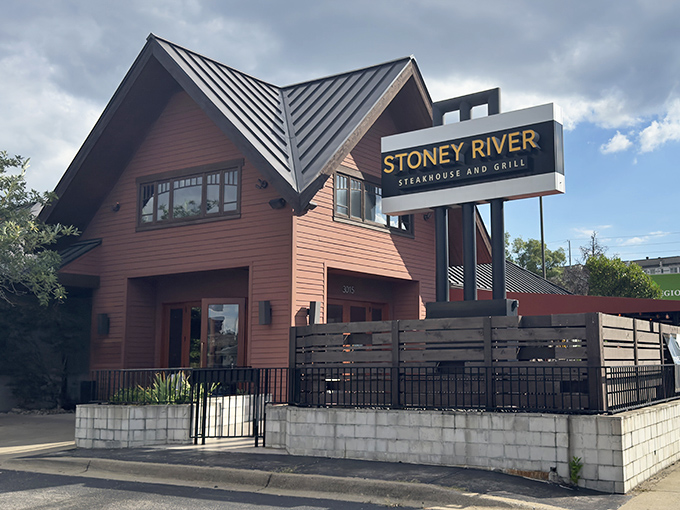 From another angle, the distinctive peaked roof and warm wooden facade create an inviting first impression that whispers, "Come in, carnivores welcome."