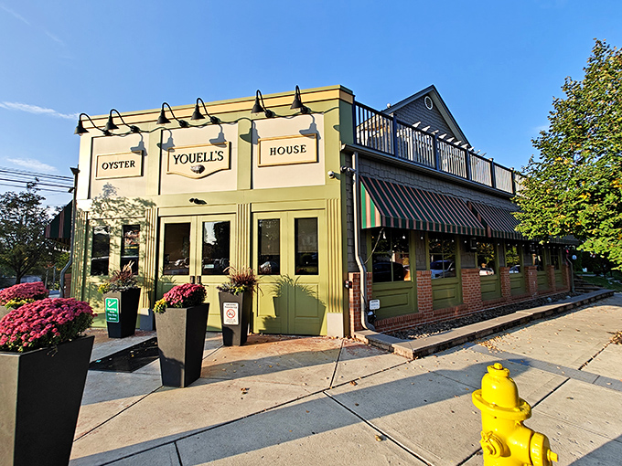 Bathed in golden sunlight, Youell's charming exterior promises seafood treasures within. That yellow fire hydrant? It's practically jumping for joy about being so close to crab cake heaven.