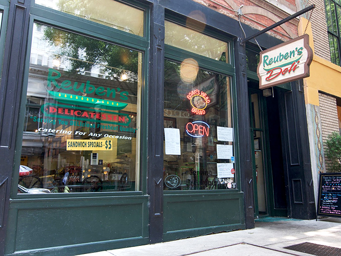 The unassuming brick façade of Reuben's Deli in downtown Atlanta – where sandwich greatness hides behind Coca-Cola signs and zero pretension.