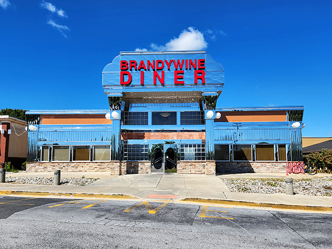 The iconic blue and red neon sign of Brandywine Diner stands proud against a clear Delaware sky, beckoning hungry travelers like a culinary lighthouse.