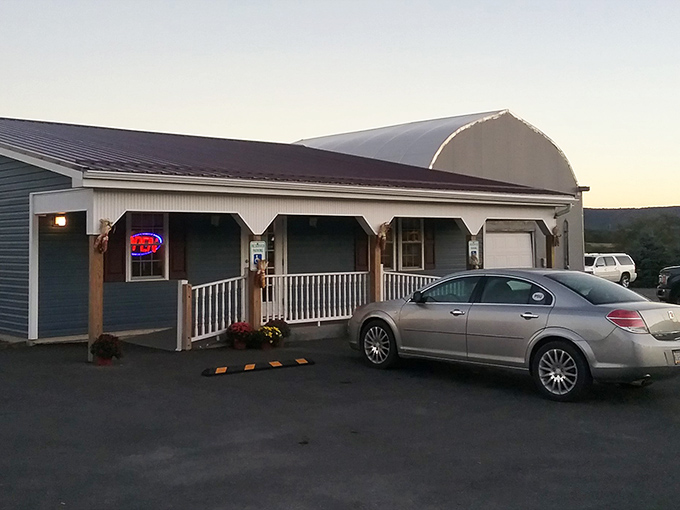The unassuming exterior of Earlystown Diner welcomes hungry travelers with its charming country porch and promise of home-cooked comfort waiting inside.