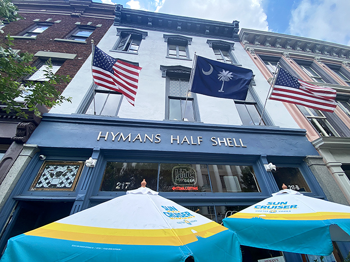 Flags flutter proudly above Hyman's Half Shell, where Southern hospitality meets maritime tradition in downtown Charleston's culinary landscape.