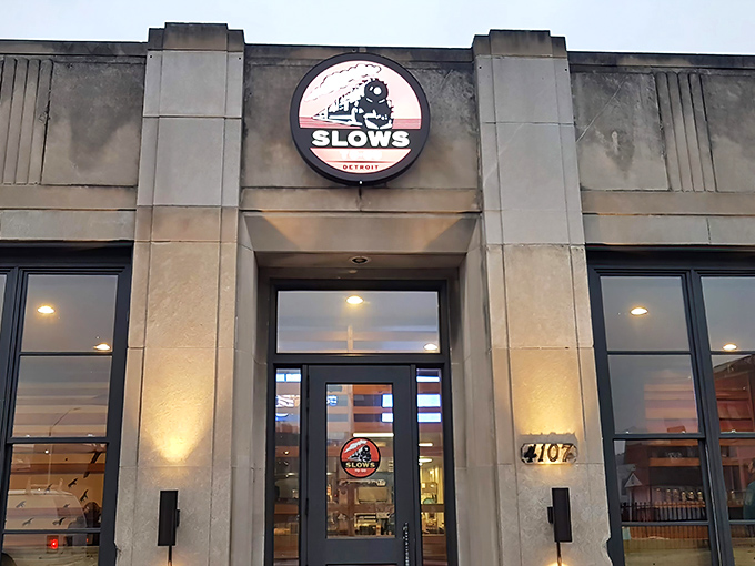 The stone fortress of flavor! Slows To Go's ivy-covered exterior with its iconic vertical sign promises barbecue nirvana in Detroit's Corktown neighborhood.