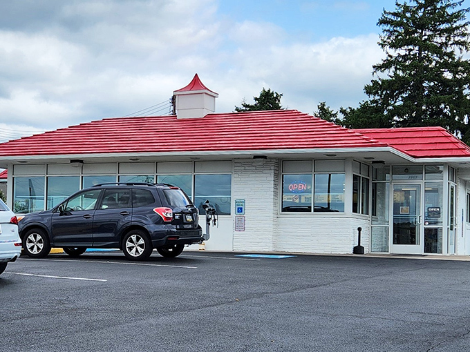 The iconic red-striped roof of Speck's stands as a beacon of hope for hungry travelers. No fancy architecture needed when the chicken's this good.