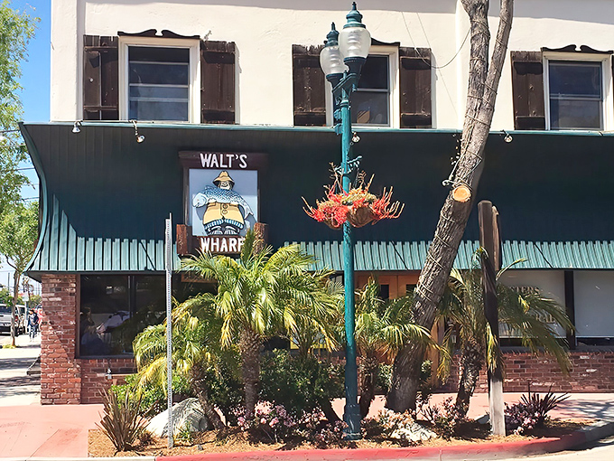 Walt's Wharf stands proudly on Main Street in Seal Beach, its iconic green awning and fisherman sign beckoning seafood lovers like a lighthouse to hungry sailors.