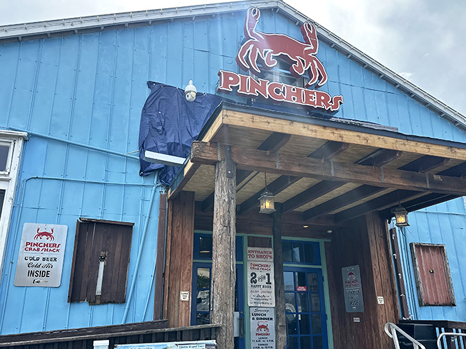 The bright blue exterior of Pinchers stands like a cheerful rebellion against Florida's beige landscape, promising seafood adventures with every creaking board of its weathered deck.