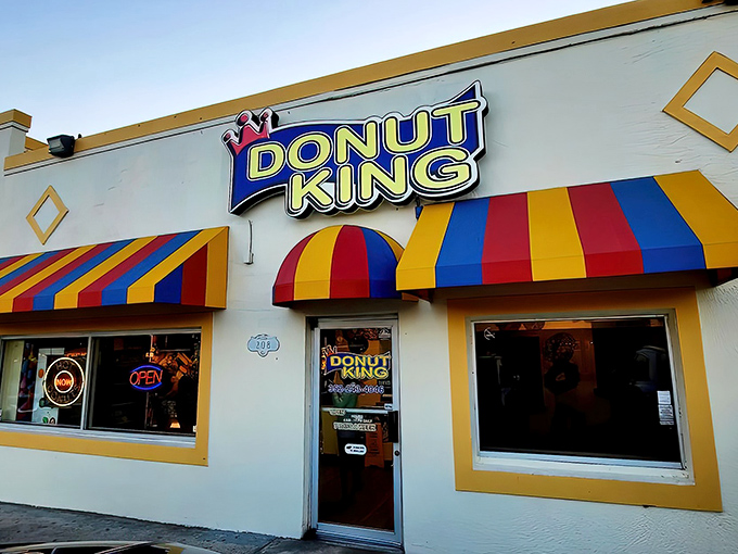 The colorful awnings of Donut King stand out like a beacon of sweetness on Highway 27, promising delicious treasures within.