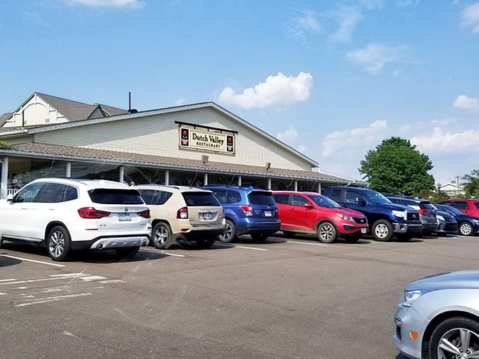 The welcoming yellow exterior of Dutch Valley Restaurant stands like a beacon of comfort food in Sugarcreek's rolling countryside. Those hanging flower baskets aren't just for show!