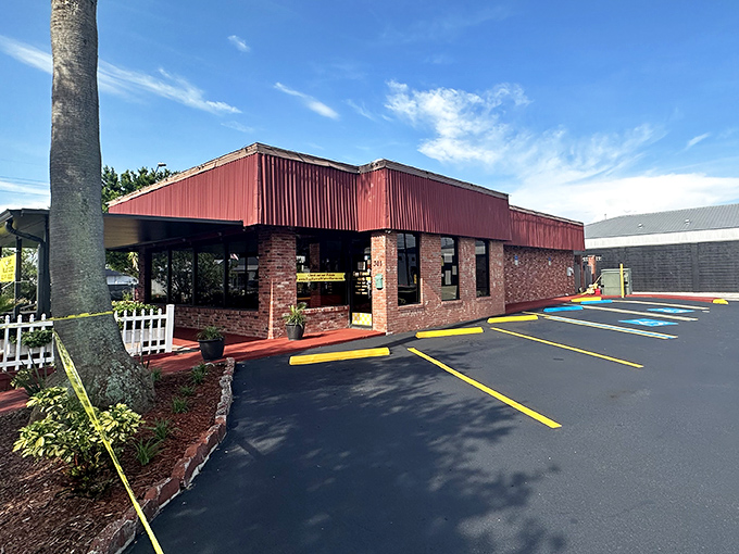 The brick-and-red-metal exterior of Egg Haven stands like a breakfast beacon in Winter Haven, promising comfort food that's worth the journey.