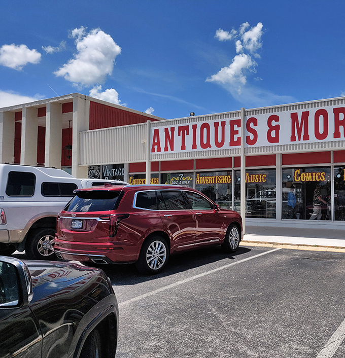 The unassuming exterior belies the treasure trove within. Like a time-travel portal disguised as a strip mall storefront, Wildwood beckons with its simple "ANTIQUES & MORE" promise. 