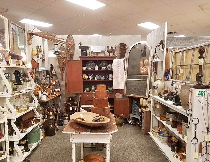 Organized chaos at its finest! This vendor's carefully curated corner showcases everything from vintage snowshoes to wooden bowls, proving the best antique booths tell stories through objects.