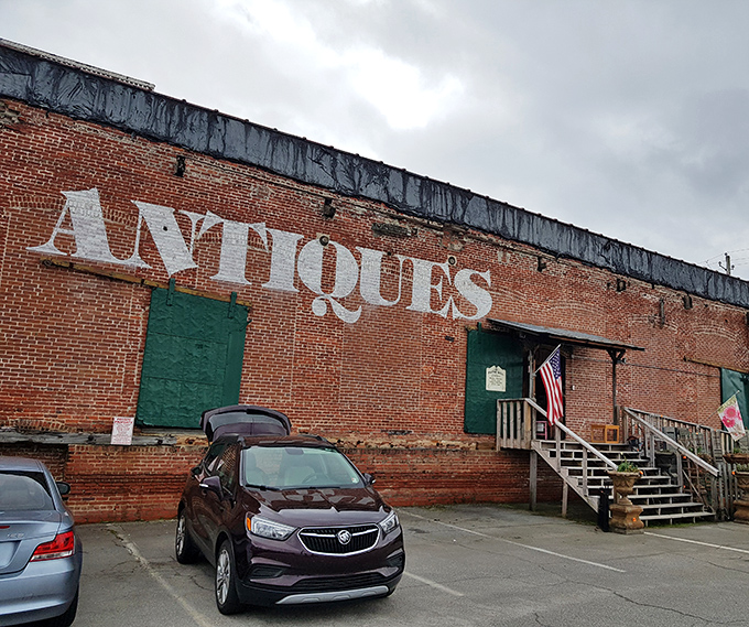 The brick exterior boldly announces "ANTIQUES" like a time-travel invitation written in giant letters. No DeLorean required&mdash;just an appreciation for history and comfortable walking shoes.