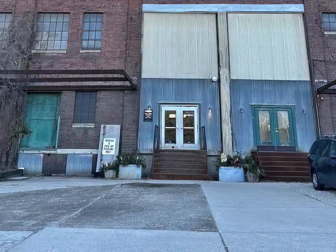 A closer view of the entrance reveals the building's character - those factory doors now welcome treasure hunters instead of factory workers.
