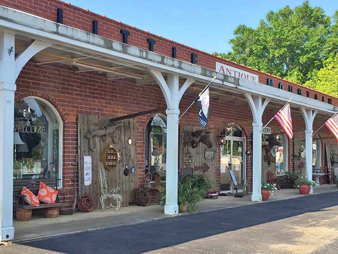The welcoming facade of Little Mountain Unlimited beckons with its charming white columns and rustic brick, like a southern porch that's seen generations of stories unfold.