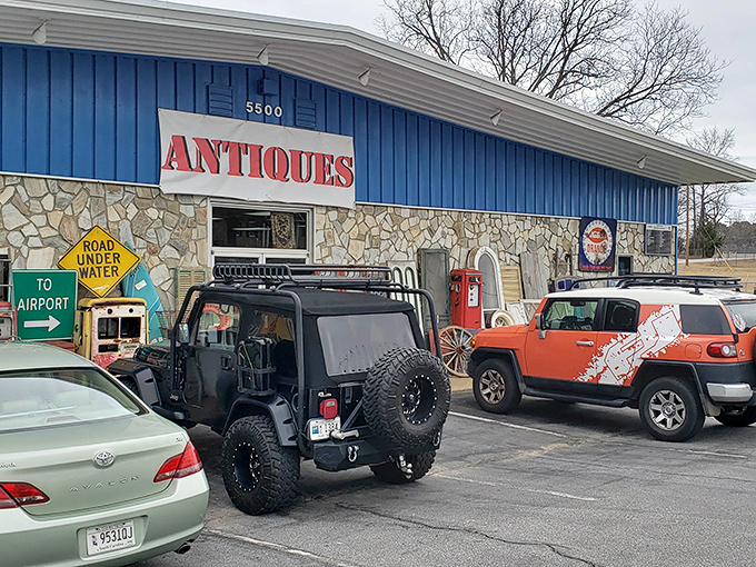 The blue facade of The Vintage Market stands like a portal to the past, with treasures spilling onto the sidewalk as if the building couldn't contain its own history.