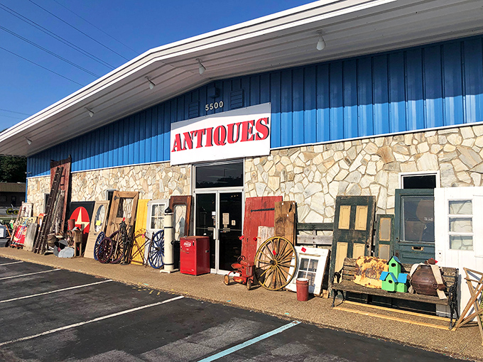The blue facade of The Vintage Market stands like a portal to the past, with treasures spilling onto the sidewalk as if the building couldn't contain its own history.