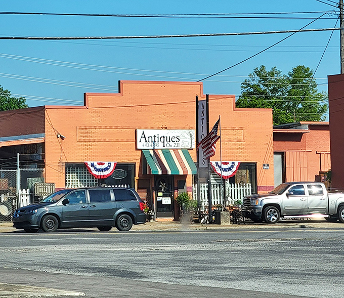 The cheerful orange facade of Antiques On 231 stands like a beacon for treasure hunters, complete with patriotic bunting that practically screams "Americana inside!"