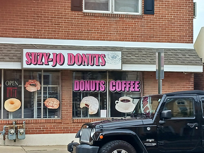 The pink sign beckons like a sweet siren call. This unassuming brick storefront houses donut magic that puts national chains to shame.