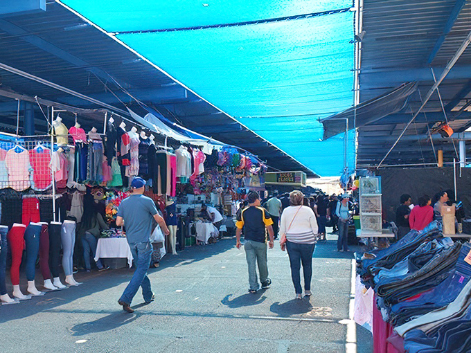 Blue tarps create instant shade galleries where shopping becomes an adventure under the Arizona sun.