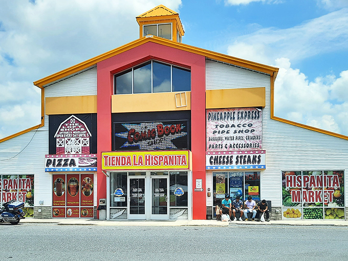 The vibrant red and yellow exterior of Laurel Junction Flea Market stands like a beacon for treasure hunters, promising adventures in bargain paradise.