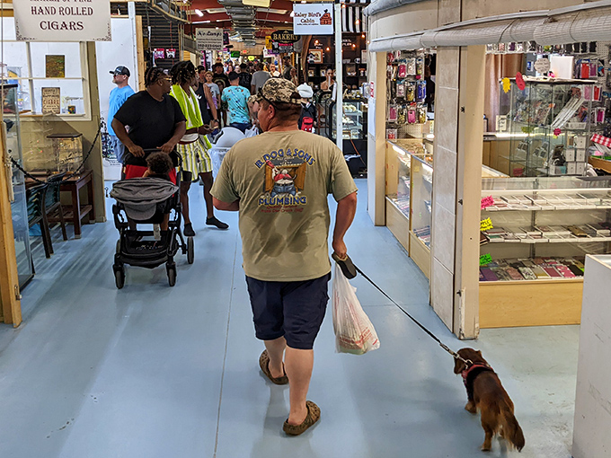 Dogs welcome! This shopper and his four-legged treasure hunting companion navigate the indoor market's endless possibilities.