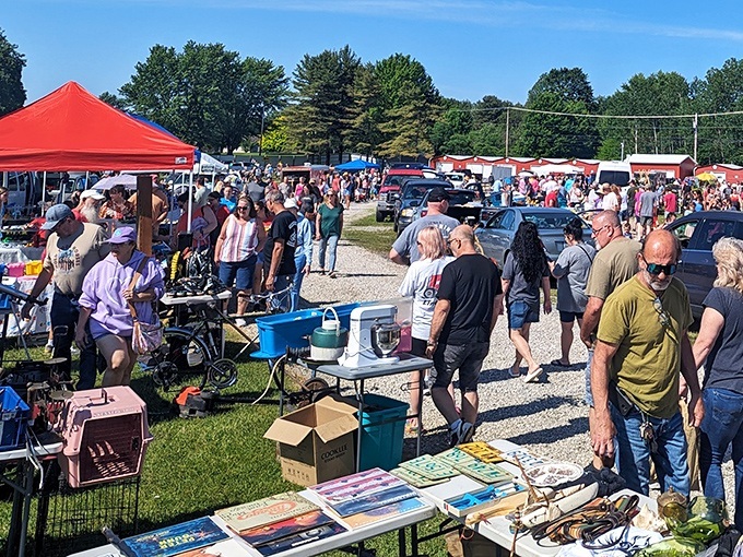 Saturday morning treasure hunters navigate the bustling pathways of Andover's marketplace, each carrying potential discoveries in plastic tubs and shopping bags.