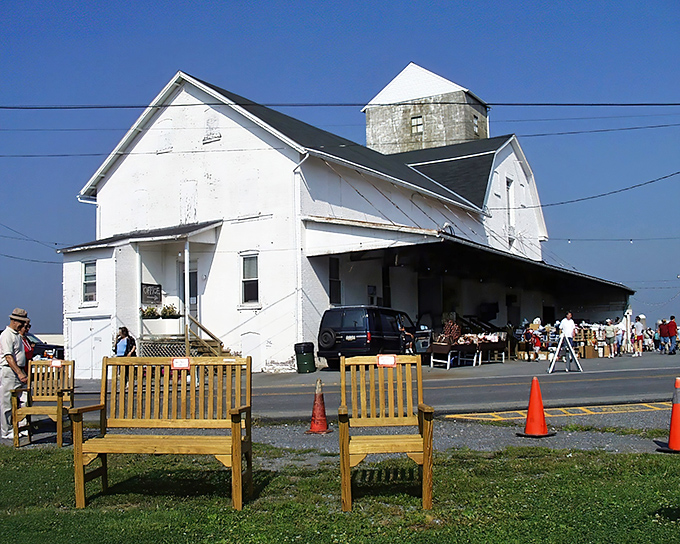The iconic white barn of Root's Old Mill stands like a treasure chest waiting to be opened, drawing bargain hunters every Tuesday to Manheim.