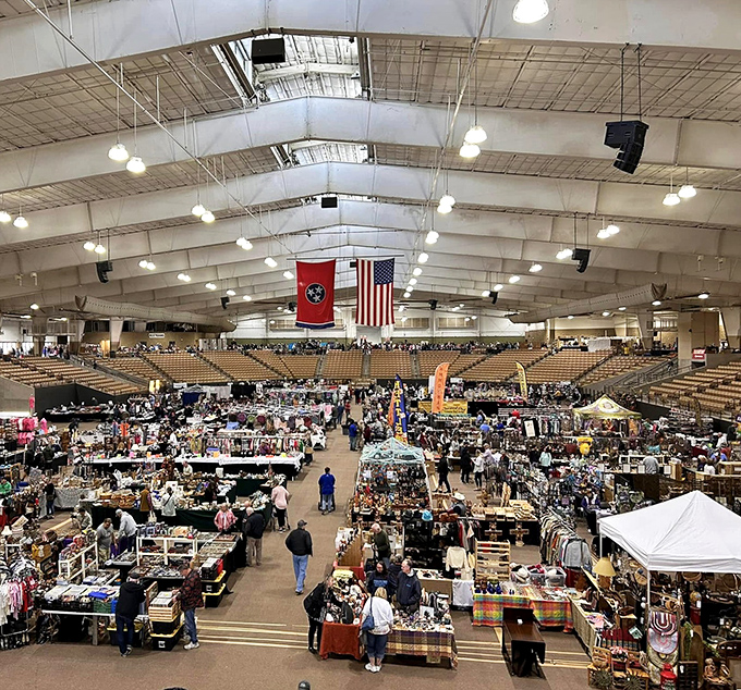 The arena transforms into a treasure hunter's paradise where thousands gather under Tennessee and American flags, proving one person's clutter creates another's joy.