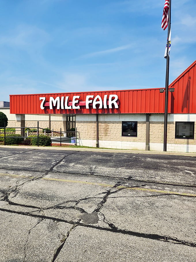 The iconic red exterior of 7 Mile Fair stands like a retail Emerald City, beckoning bargain hunters with promises of treasures within.