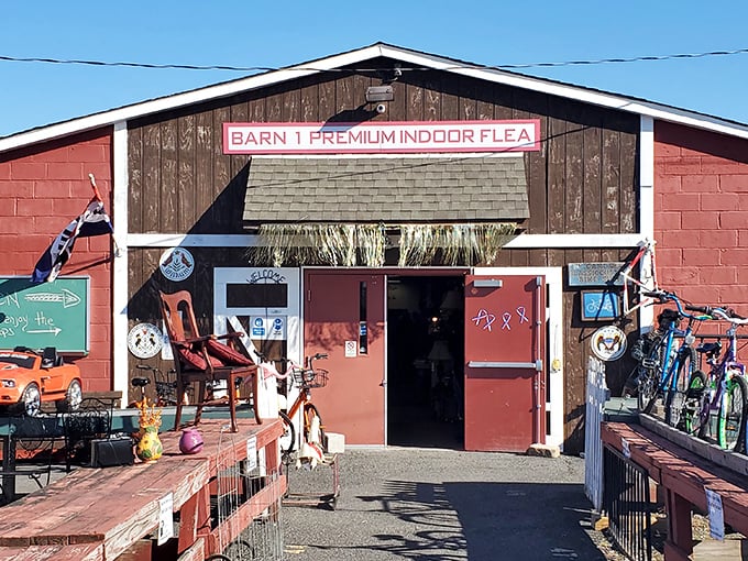 Barn 1's rustic entrance beckons treasure hunters with the promise of vintage finds and unexpected discoveries hiding just beyond those red doors.