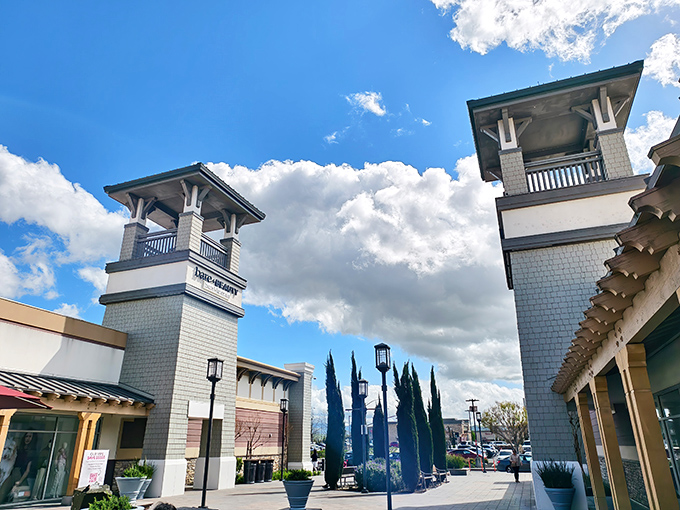 The iconic towers of San Francisco Premium Outlets stand like sentinels guarding a shopper's paradise, complete with Mediterranean-inspired architecture and California blue skies.