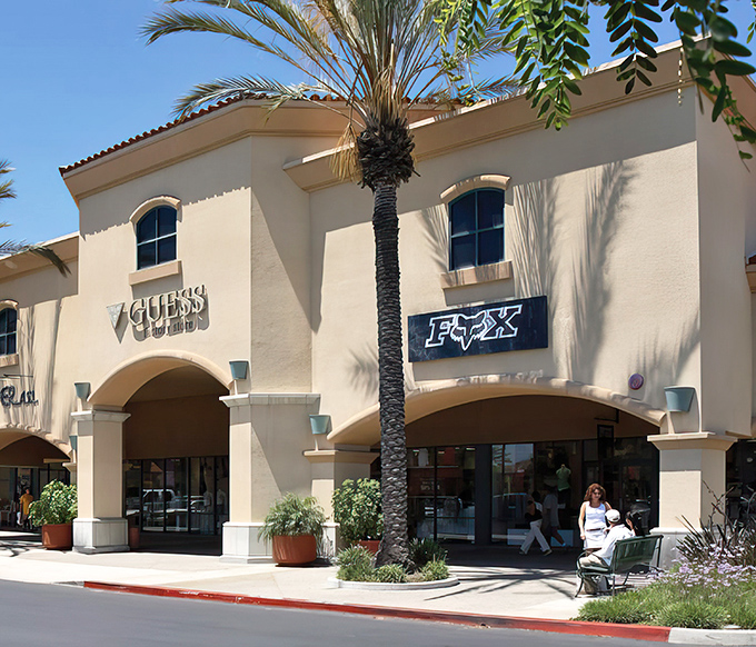 GUESS and FOX storefronts bask in California sunshine, proving that even designer brands look better with a golden-hour glow.