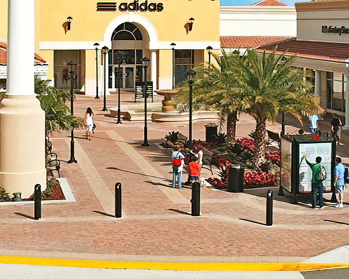 Mediterranean charm meets retail therapy at Orlando International Premium Outlets, where palm trees and terracotta roofs create the illusion you're not about to demolish your credit card.