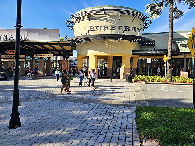 The iconic Burberry storefront at Sawgrass Mills stands like a beacon for bargain-hunting fashionistas. Palm trees and pristine walkways set the scene for serious shopping adventures.