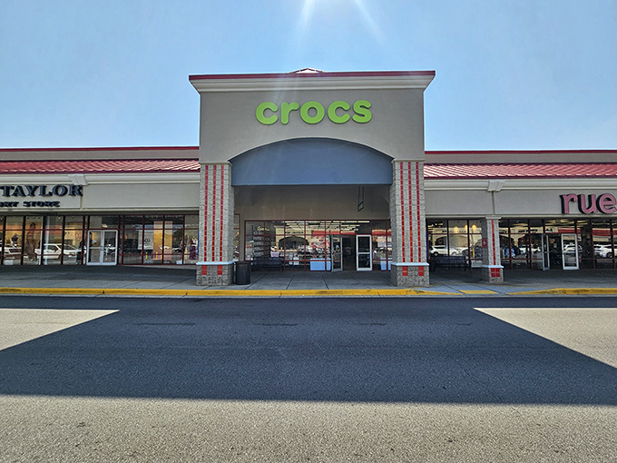 Crocs takes center stage with its bright green sign and inviting storefront, luring shoppers inside for a dose of comfort and quirky style.