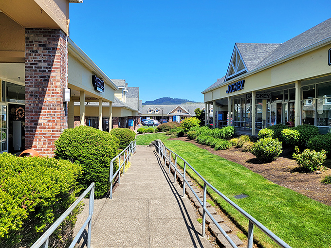 Manicured pathways and lush landscaping create an outdoor shopping experience that feels more like a coastal garden stroll than a bargain-hunting expedition.