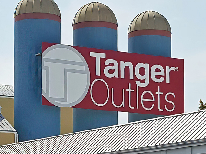 The iconic Tanger Outlets sign welcomes bargain hunters to a retail wonderland where wallets tremble but spirits soar.