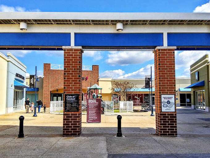 Welcome to retail paradise! The brick entryway of Philadelphia Premium Outlets stands like a gateway to bargain heaven, inviting shoppers to discover treasures beyond. 