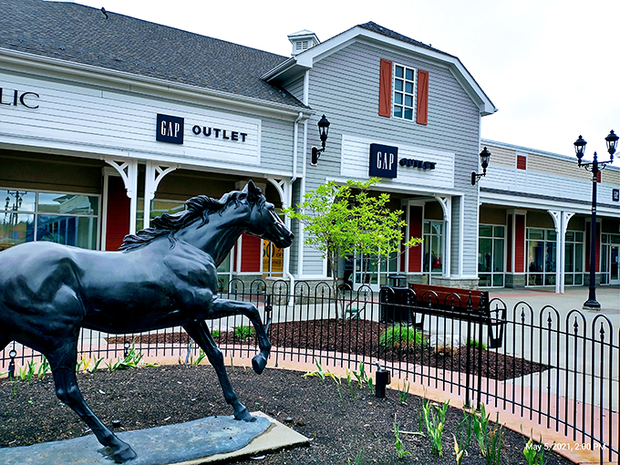 The iconic horse statue gallops eternally between colorful barn-inspired buildings, serving as both landmark and meeting point for exhausted shoppers who've lost their companions.