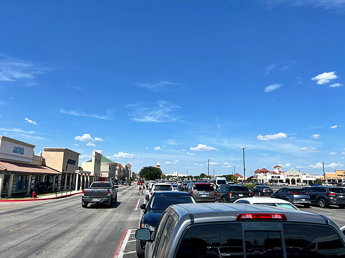 The parking lot pilgrimage begins! A sea of vehicles under that big Texas sky signals you're about to join fellow bargain hunters on sacred ground.