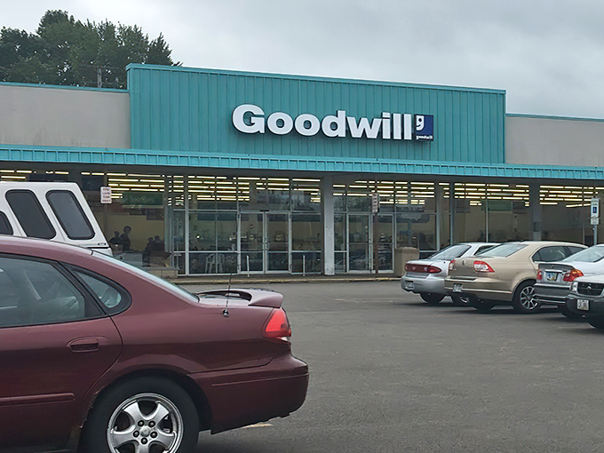 The distinctive blue "OUTLET" sign beckons bargain hunters like a retail lighthouse, promising treasures within this unassuming Akron landmark.