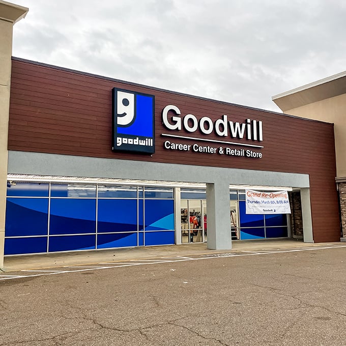 The iconic blue-framed entrance to Goodwill on I-55 beckons like a portal to a parallel universe where treasures await discovery.