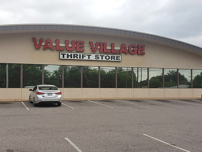The curved facade of Value Village stands like a retail rainbow, promising treasures at the end of every aisle instead of gold.